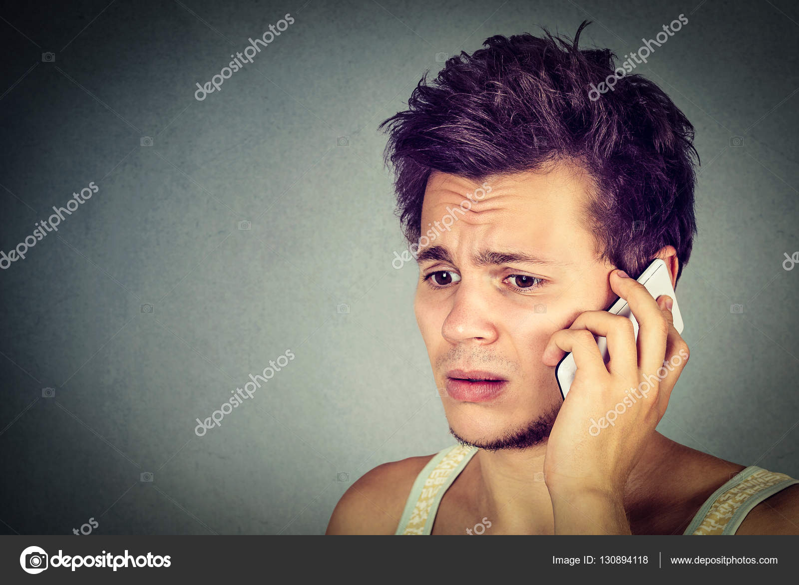 Worried young man talking on phone to someone looking upset Stock Photo ...