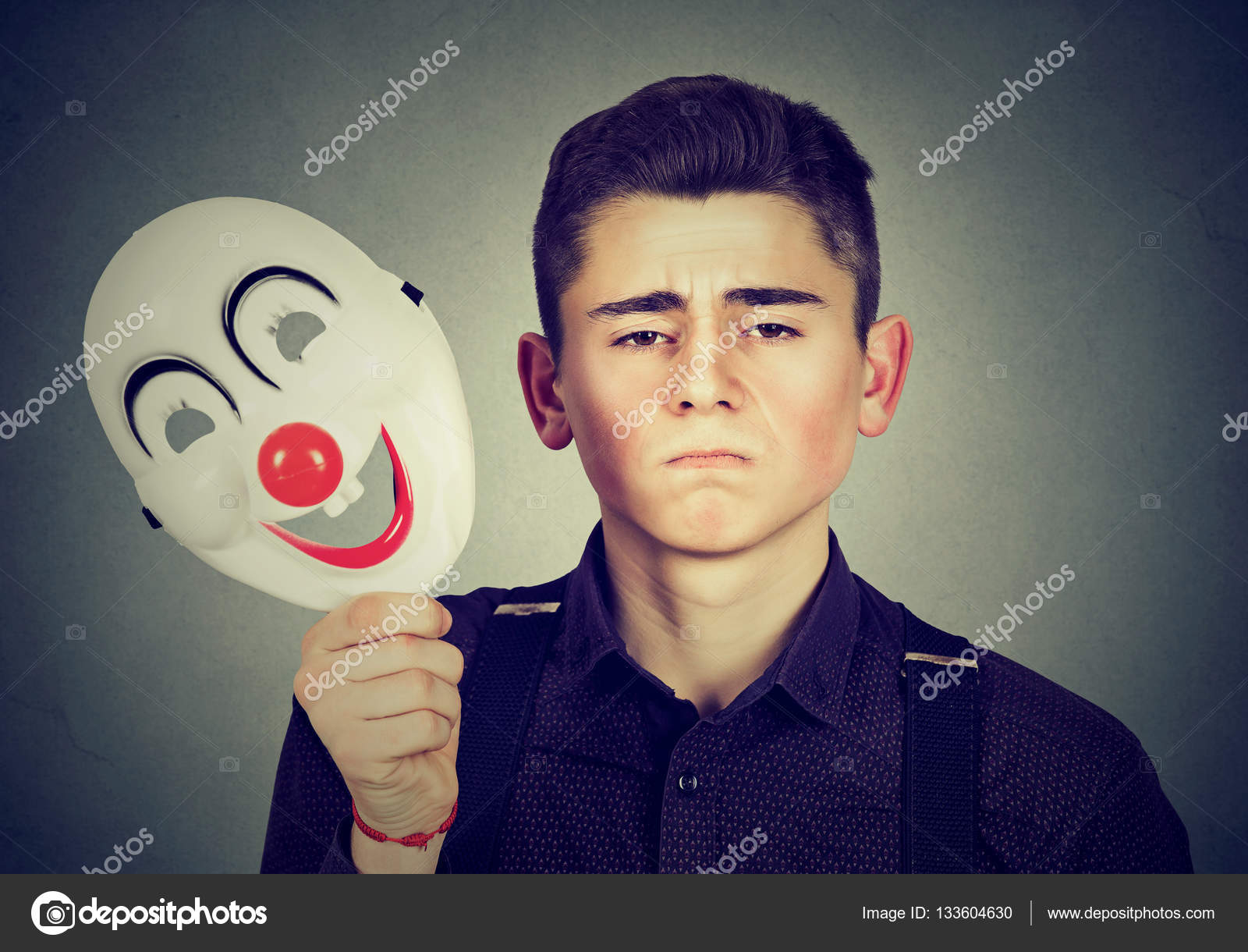 Sad man taking off happy clown mask. Split personality Stock Photo by ...