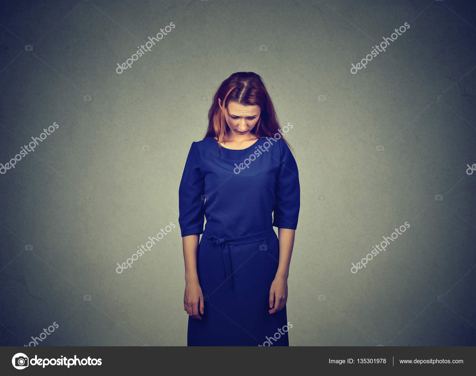 Sad shy insecure young woman standing looking down — Stock Photo ...