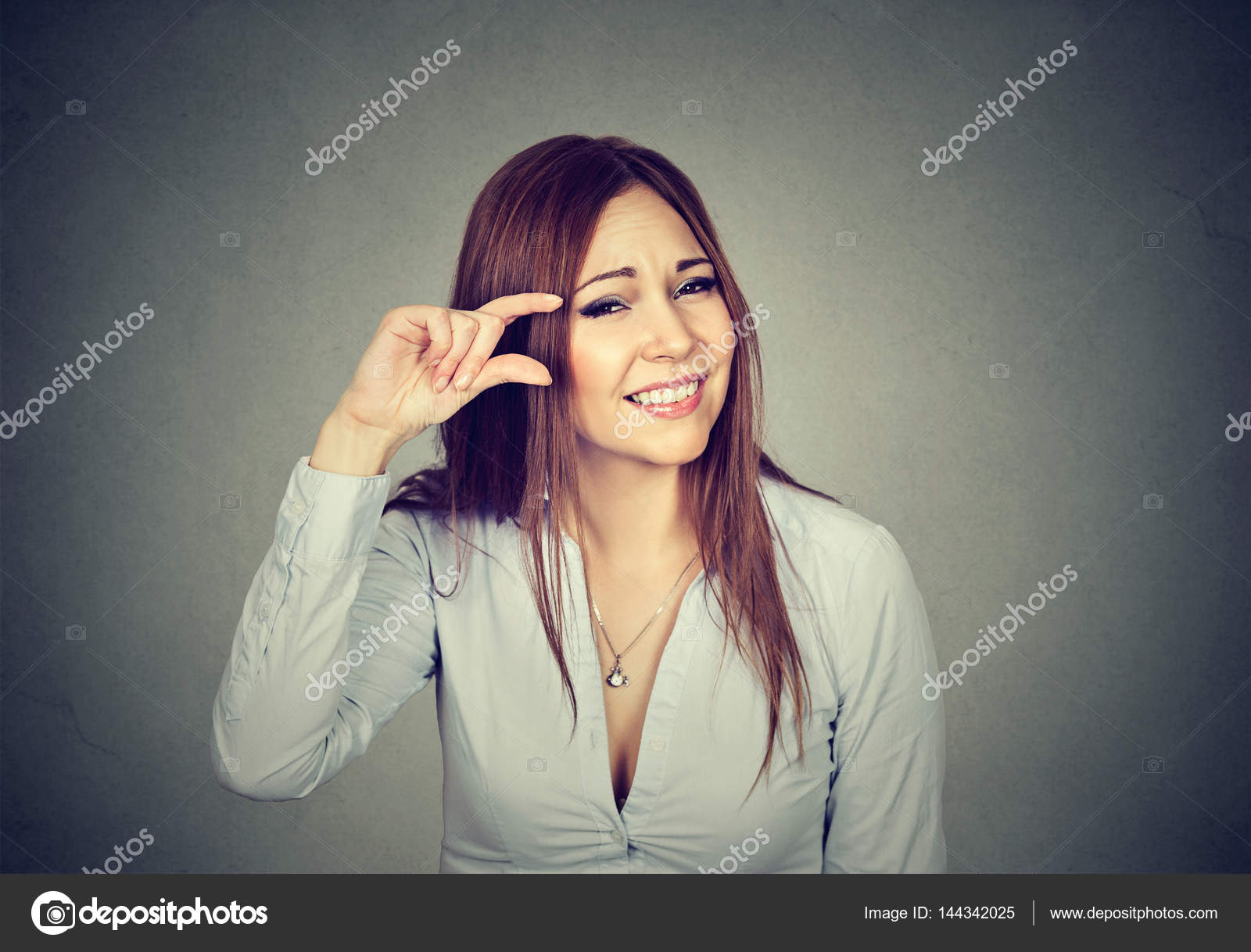 Woman showing small amount size gesture with fingers Stock Photo by ...