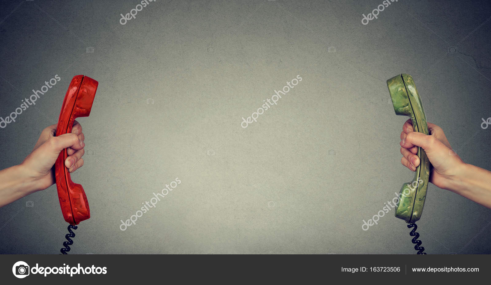 Two telephone handsets opposite each other with copy space in-between ...