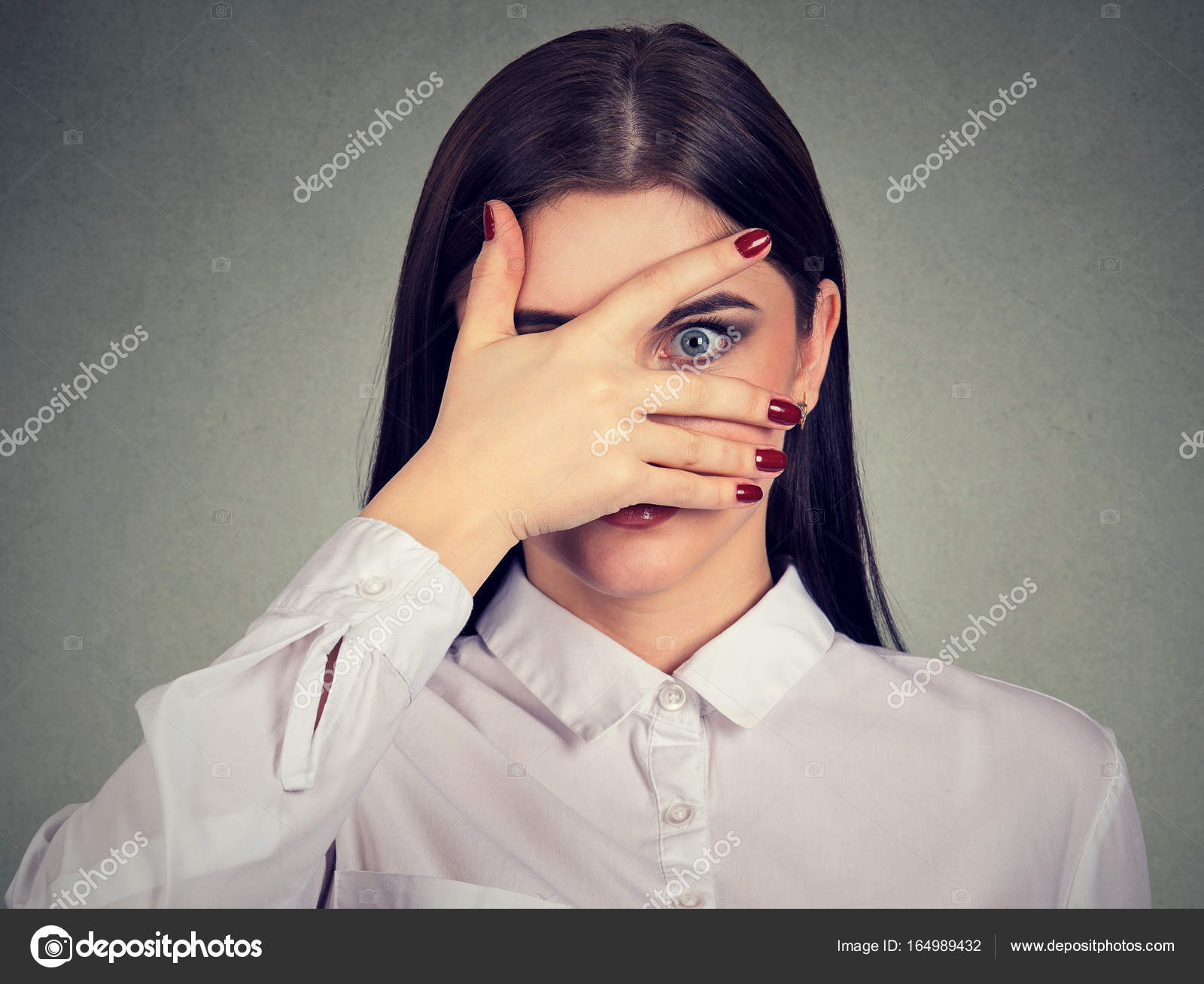 Scared young woman peeking through her fingers — Stock Photo ...