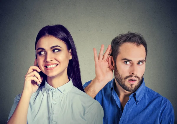 Curious worried woman secretly listening to a happy man liar talking on ...