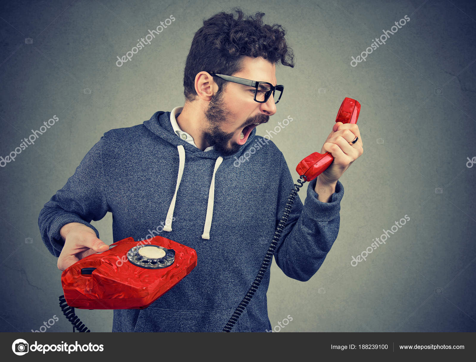 Man holding red telephone receiver and yelling in anger. Stock Photo by ...