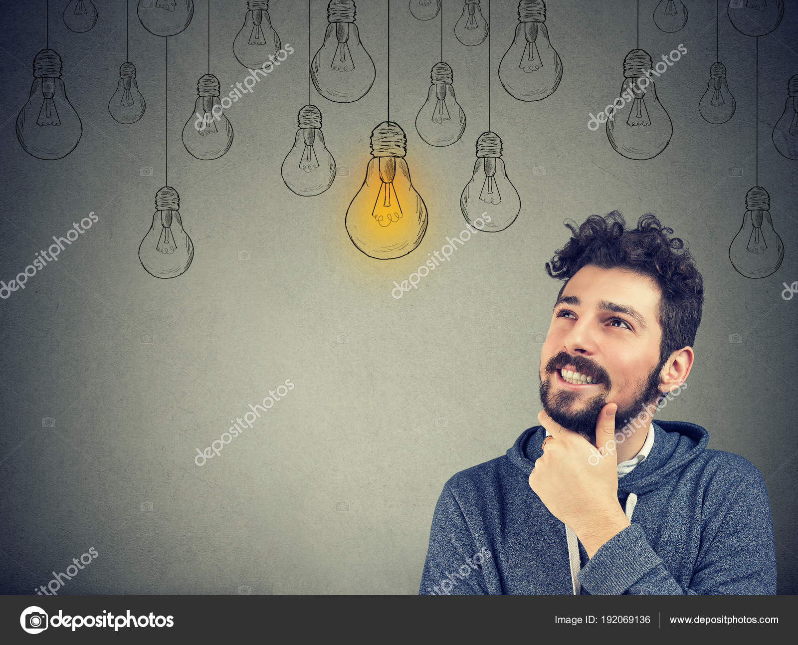 Thinking man smiling looking up at light idea bulb above head Stock ...