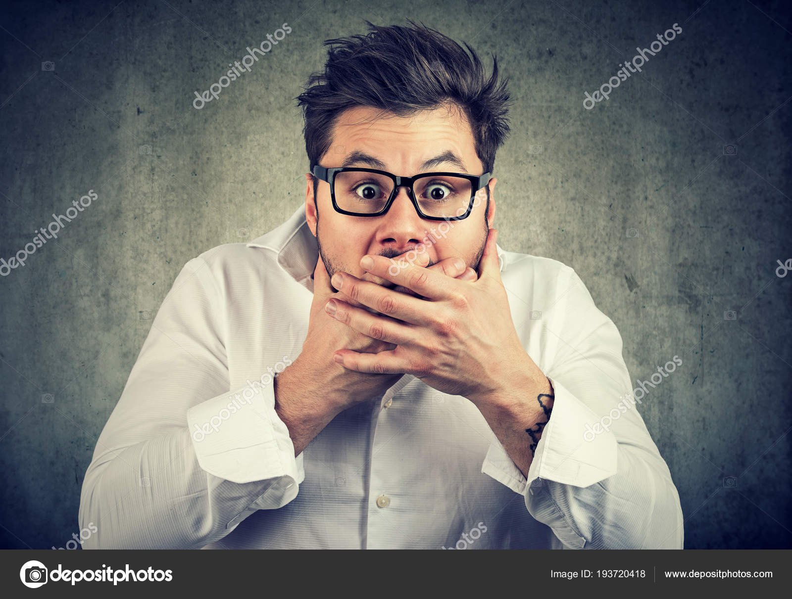 Shocked man covering mouth in fear Stock Photo by ©SIphotography 193720418