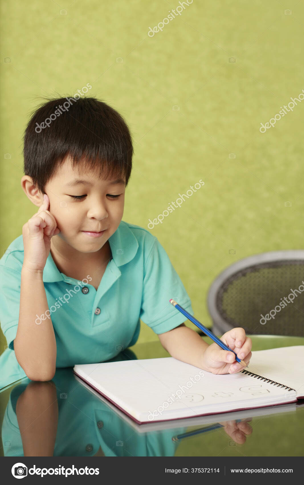 Boy Thinking While Doing Homework Stock Photo by ©image_hit 375372114