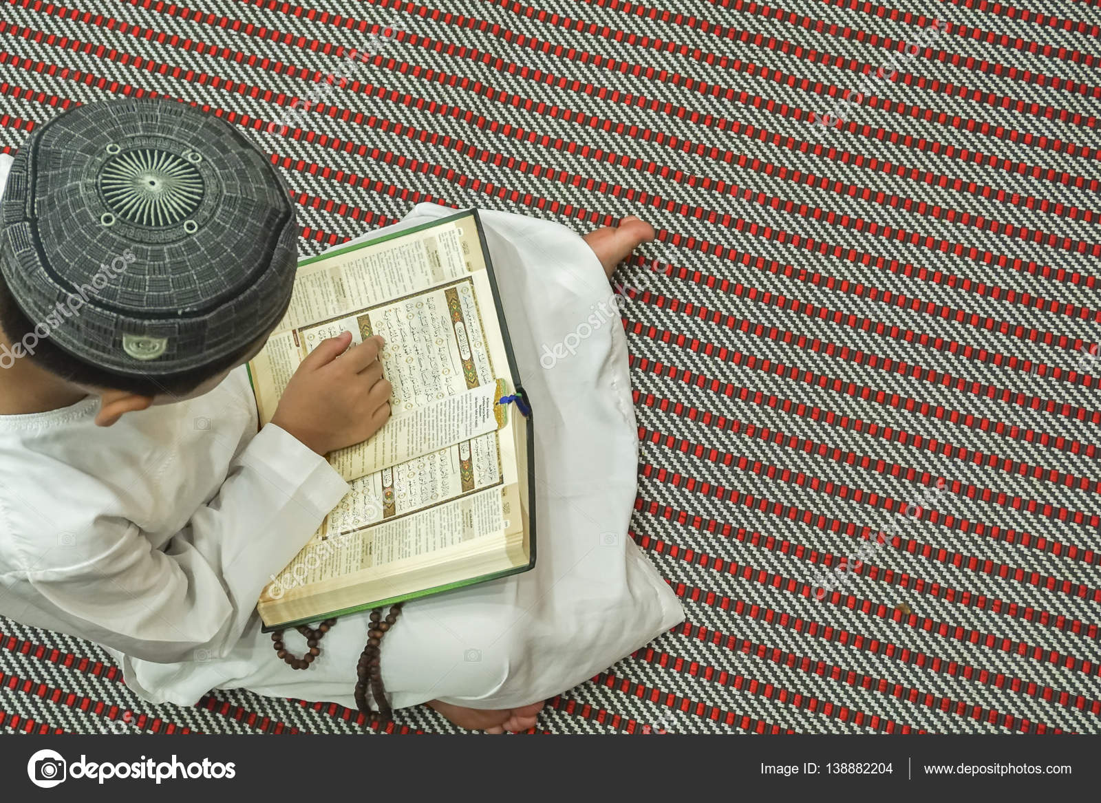 Boy reading al Quran during fasting month (Ramadhan ). DOF and copy ...