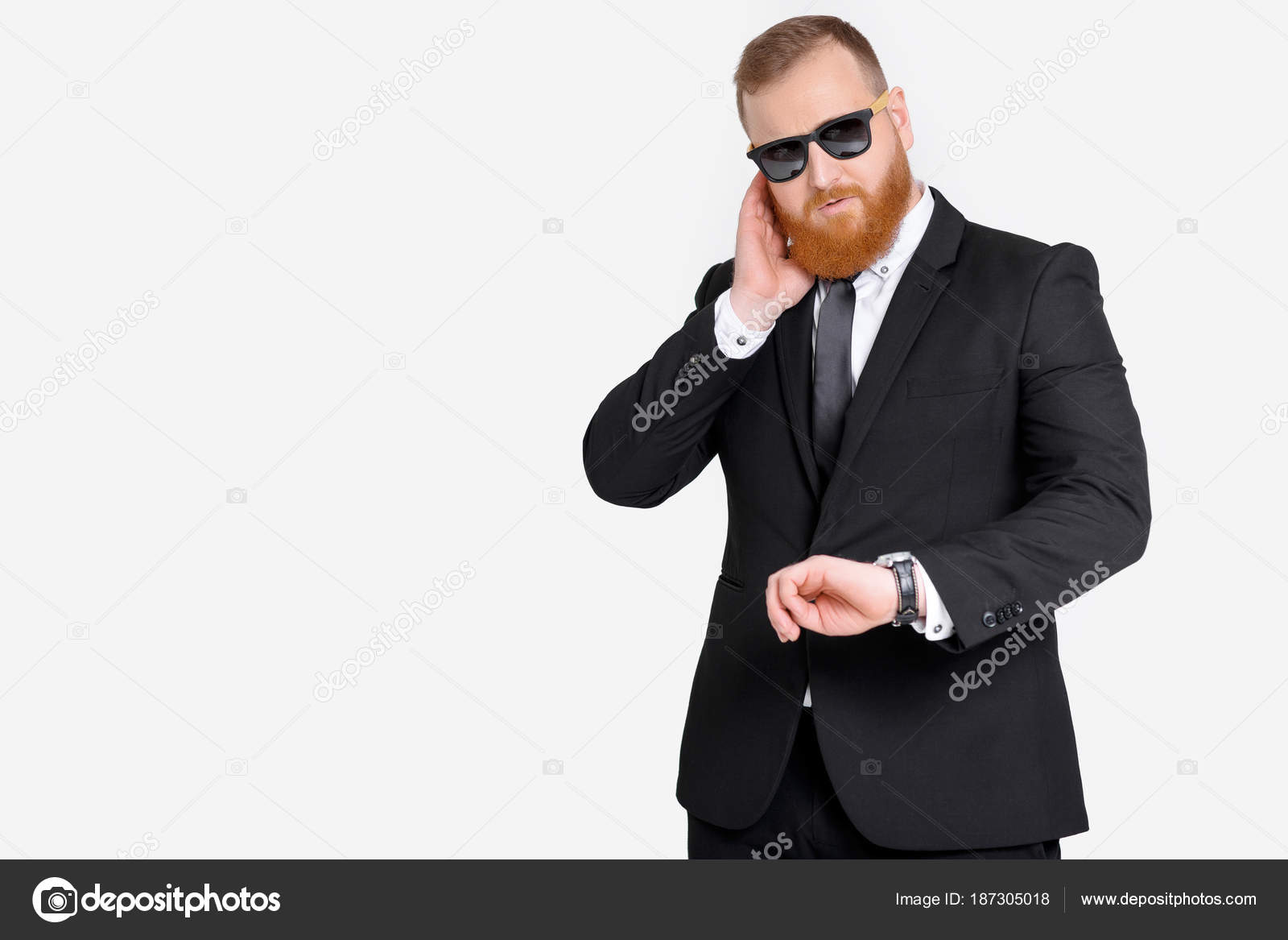 Security guard looks at watch Stock Photo by ©erstudio 187305018