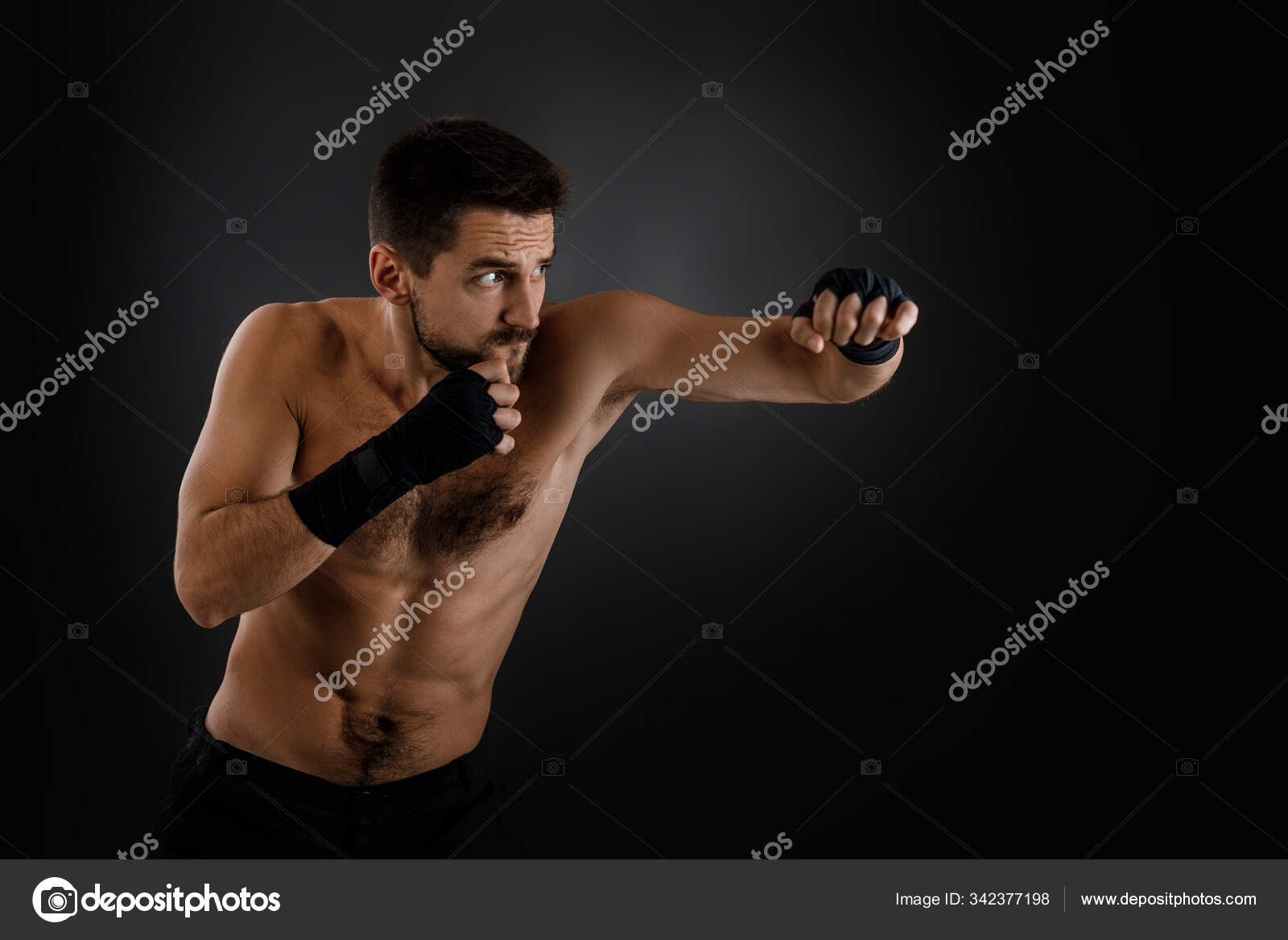 Boxer throwing a fierce and powerful punch. — Stock Photo © erstudio ...