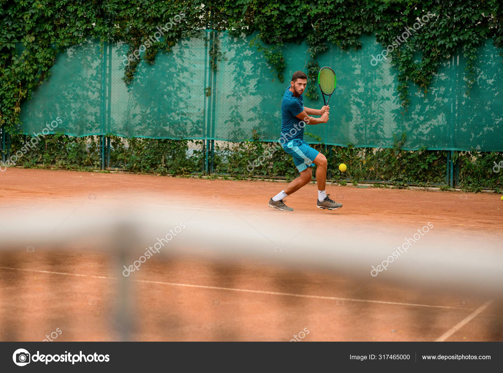 Tennis player missing the ball Young fit man during a practice at ...