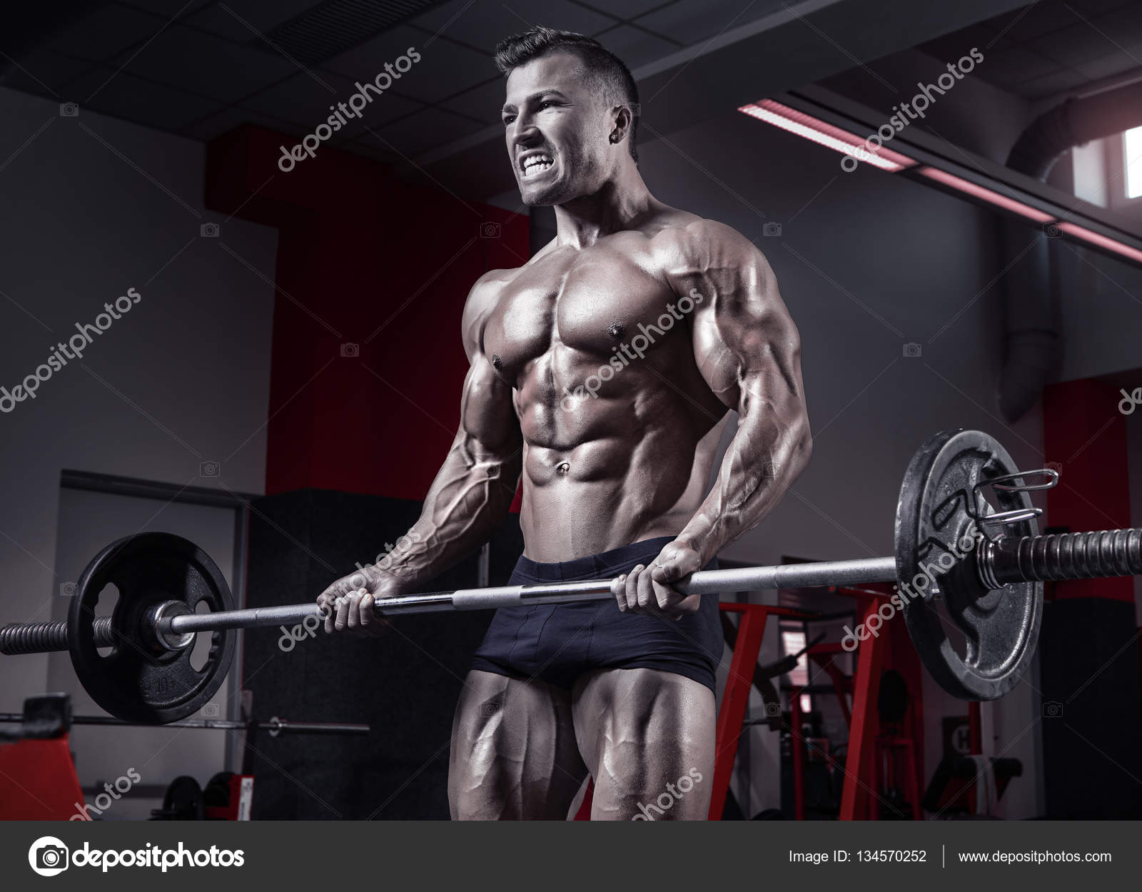 Muscular bodybuilder guy doing exercises with dumbbell Stock Photo by ...