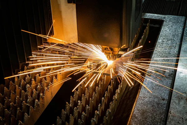 laser cutting of metal with fire splashes in the production shop of the ...