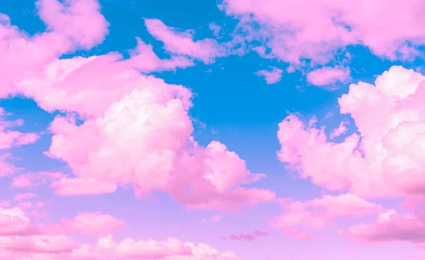 pink clouds with bright sun light on light blue sky - Stock Image ...