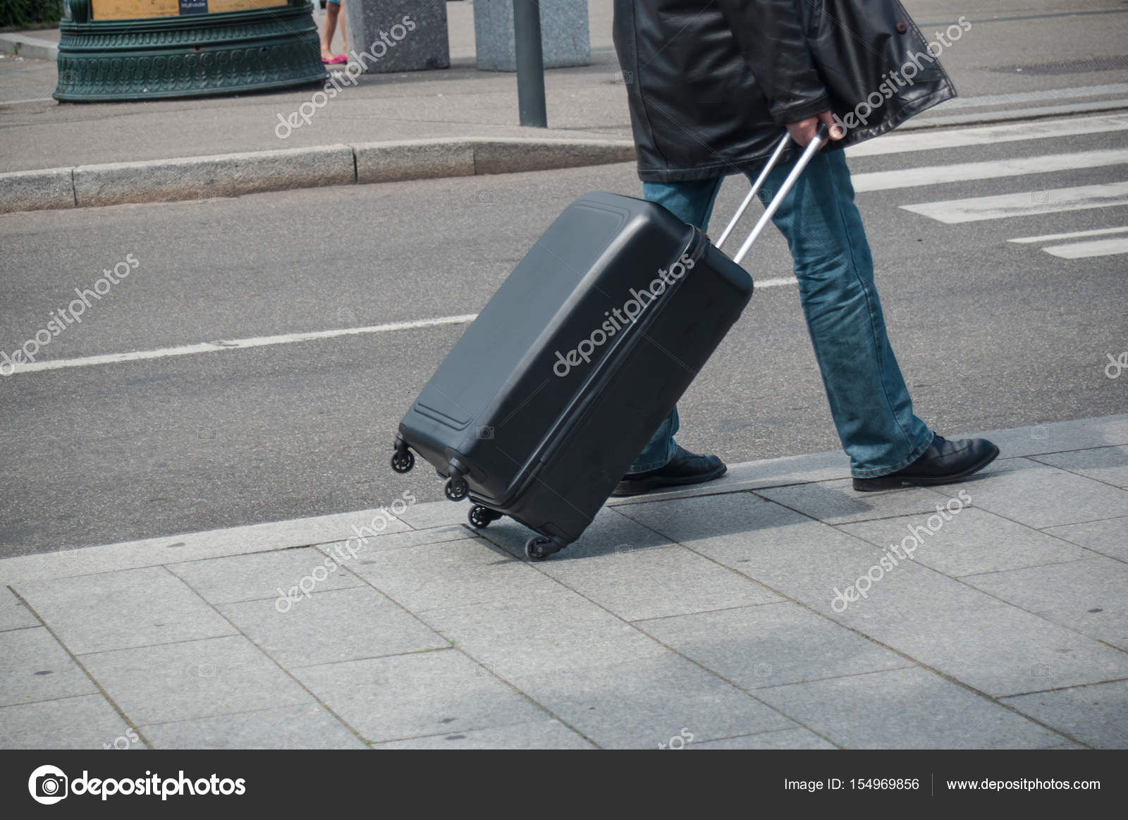 Man walking with suitcase in the street in front of t — Stock Photo ...