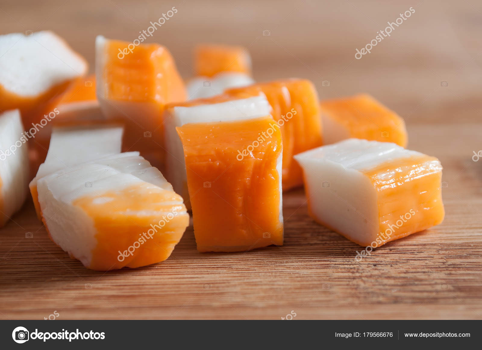 Surimi cubes on wooden cutting board — Stock Photo © NeydtStock #179566676