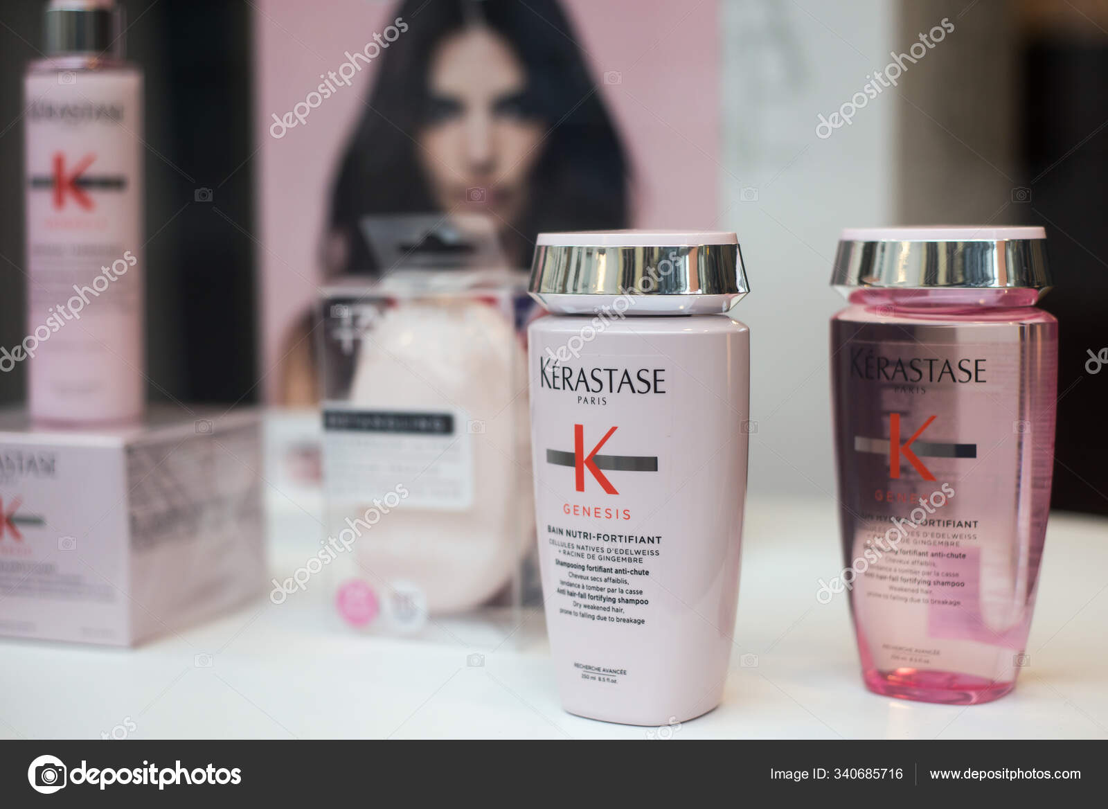 Pink shampoo and lotion bottles by Kerastase brand in a hairdresser ...
