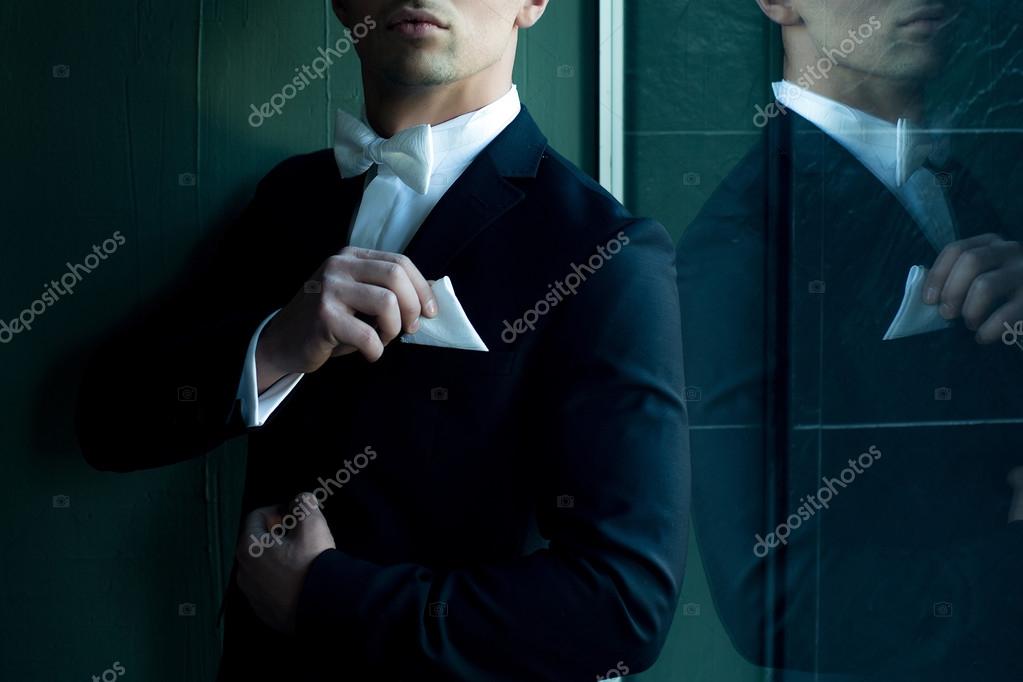 Man in suit touches handkerchief Stock Photo by ©Tverdohlib.com 125063198
