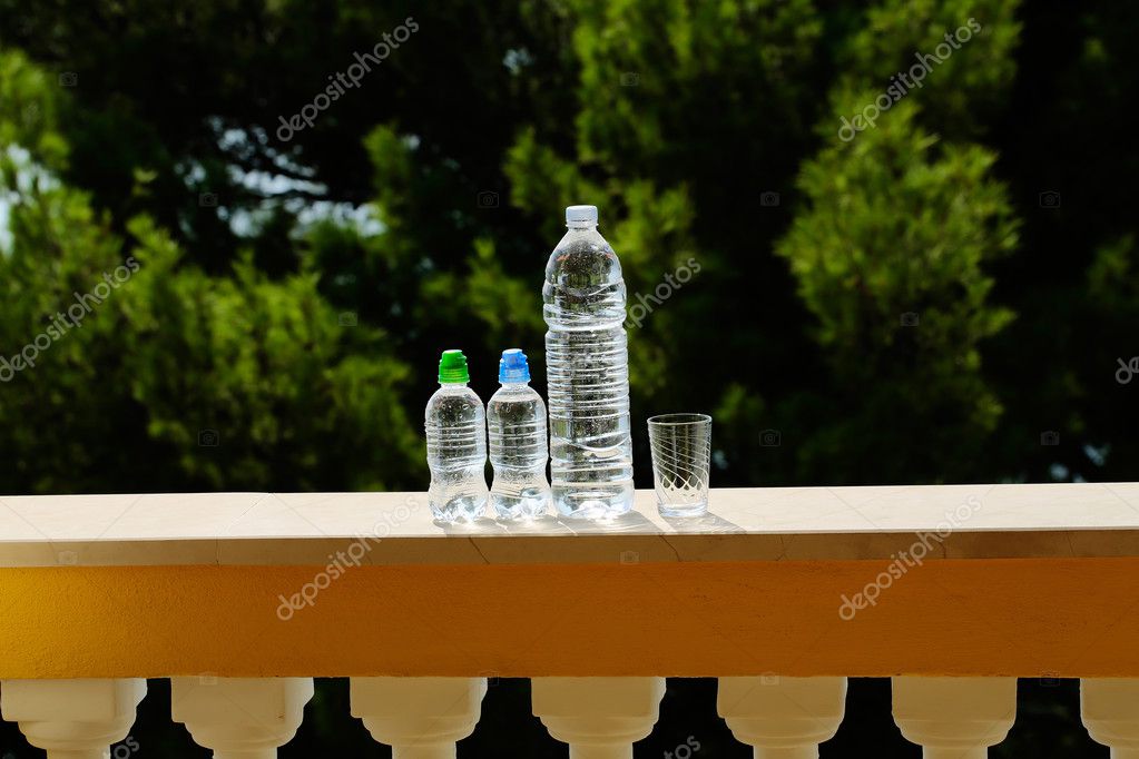 Three plastic bottles and glass Stock Photo by ©Tverdohlib.com 126035104
