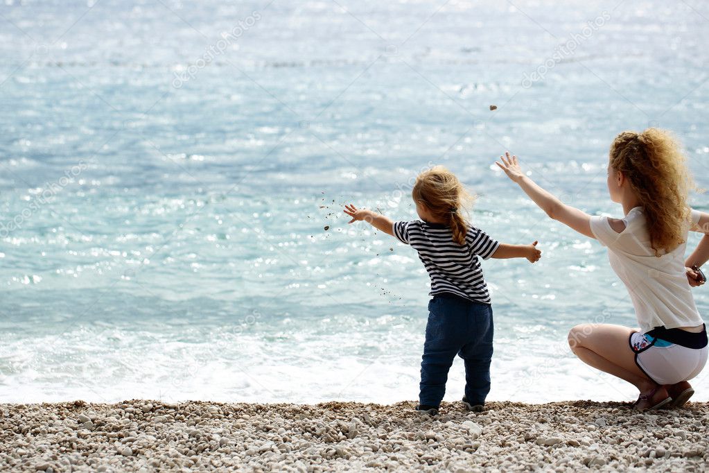 Mother and son on beach Stock Photo by ©Tverdohlib.com 126234890