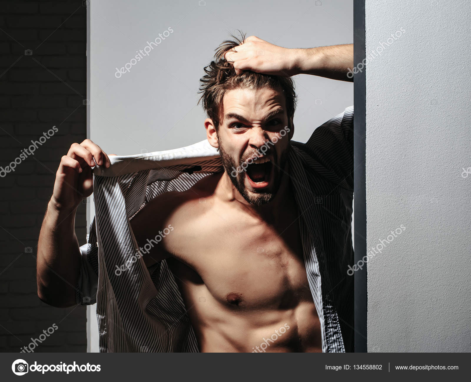 Angry man shows muscle torso Stock Photo by ©Tverdohlib.com 134558802