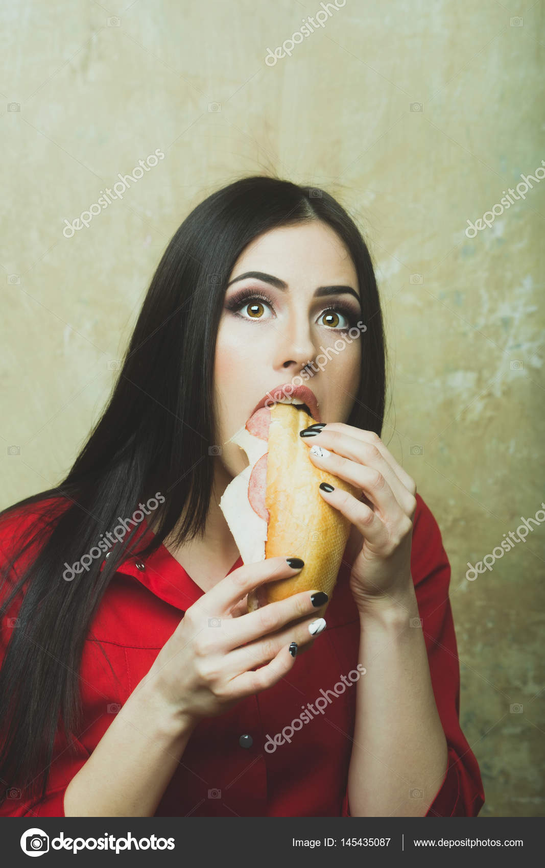 Sexy pretty brunette scared woman eats big sandwich or burger Stock ...