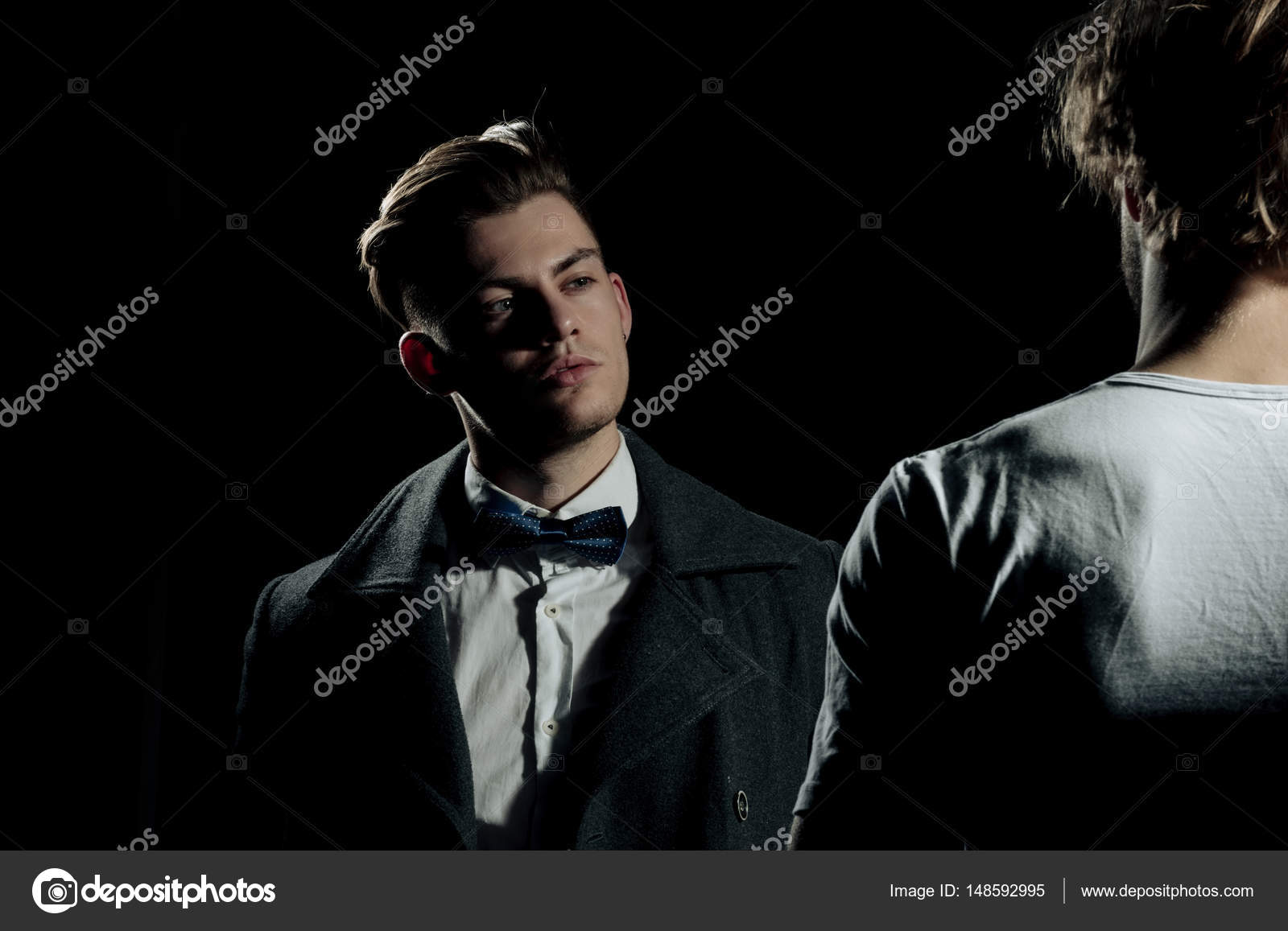 Two handsome men standing opposite Stock Photo by ©Tverdohlib.com 148592995