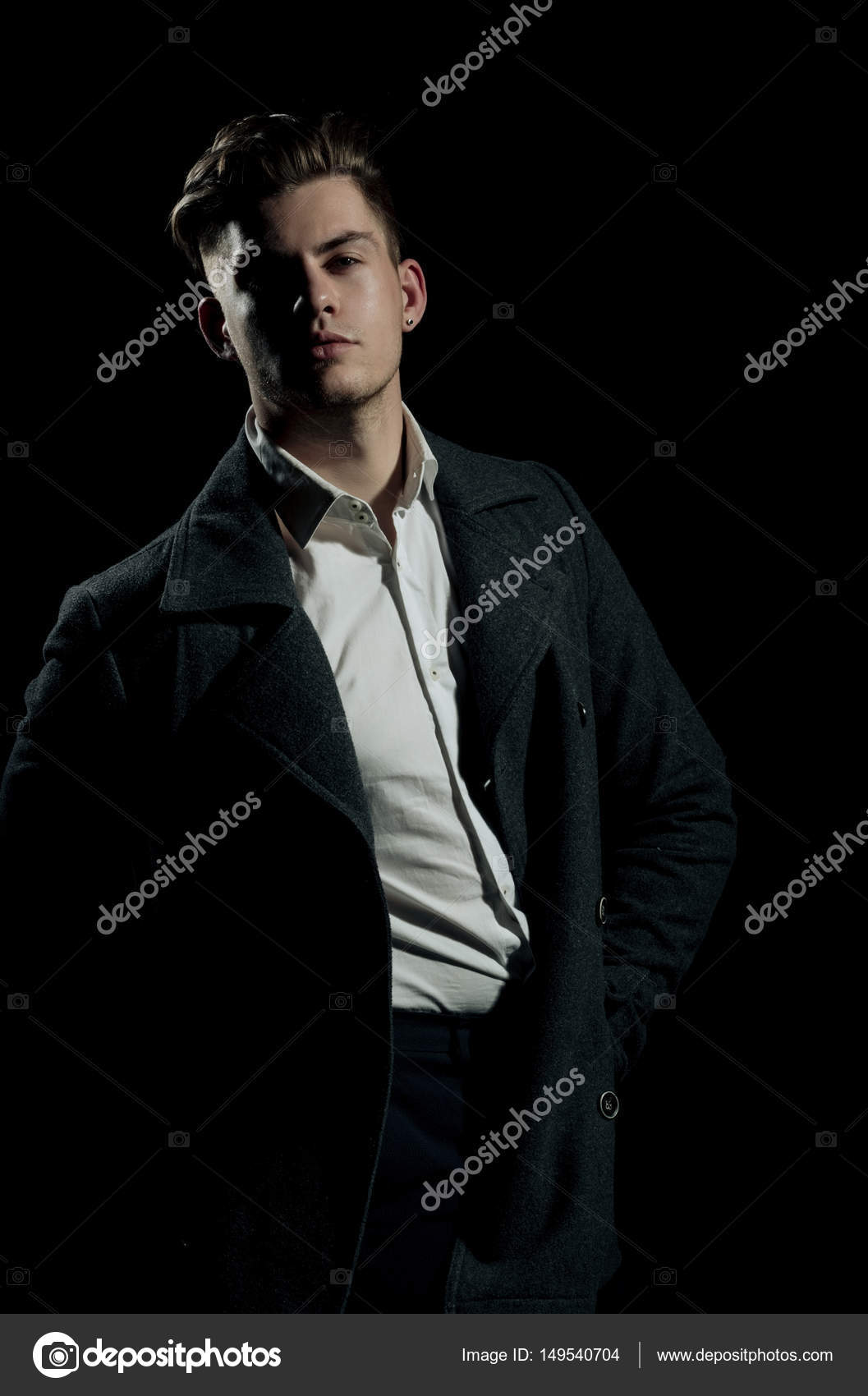 Handsome man posing in white shirt and dark coat Stock Photo by ...