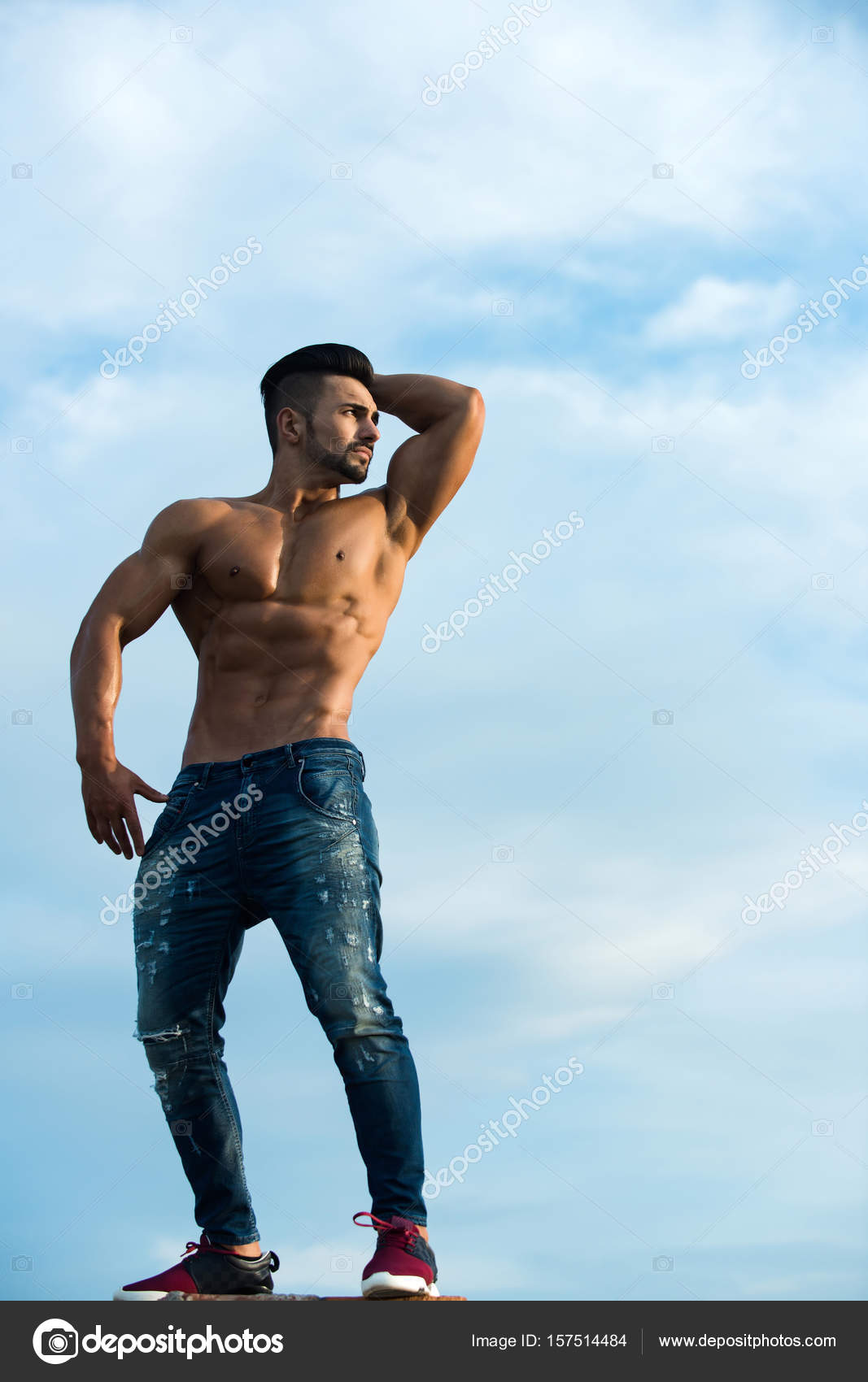 Macho man with muscular body on blue sky Stock Photo by ©Tverdohlib.com ...