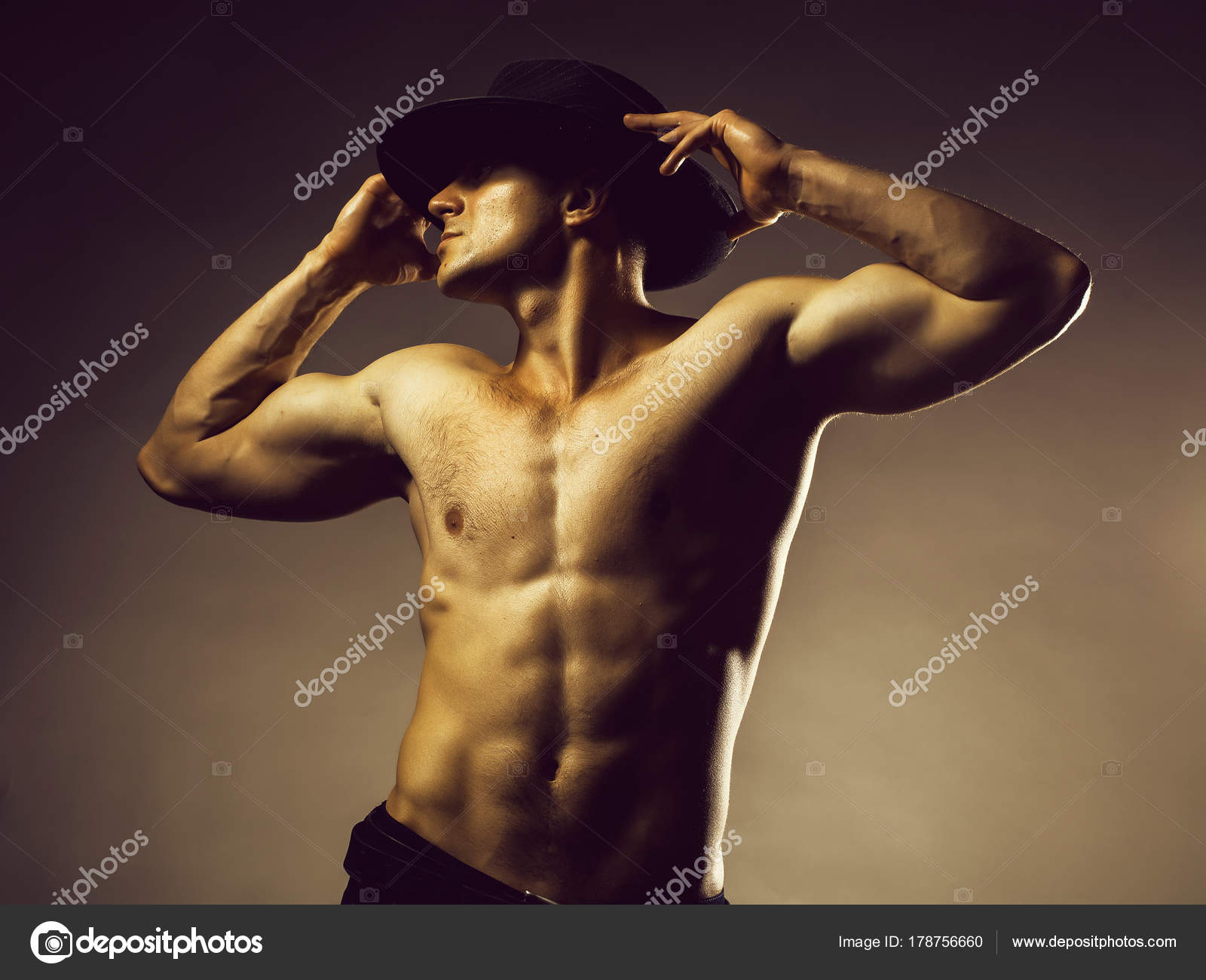 Sexy muscular man in hat Stock Photo by ©Tverdohlib.com 178756660