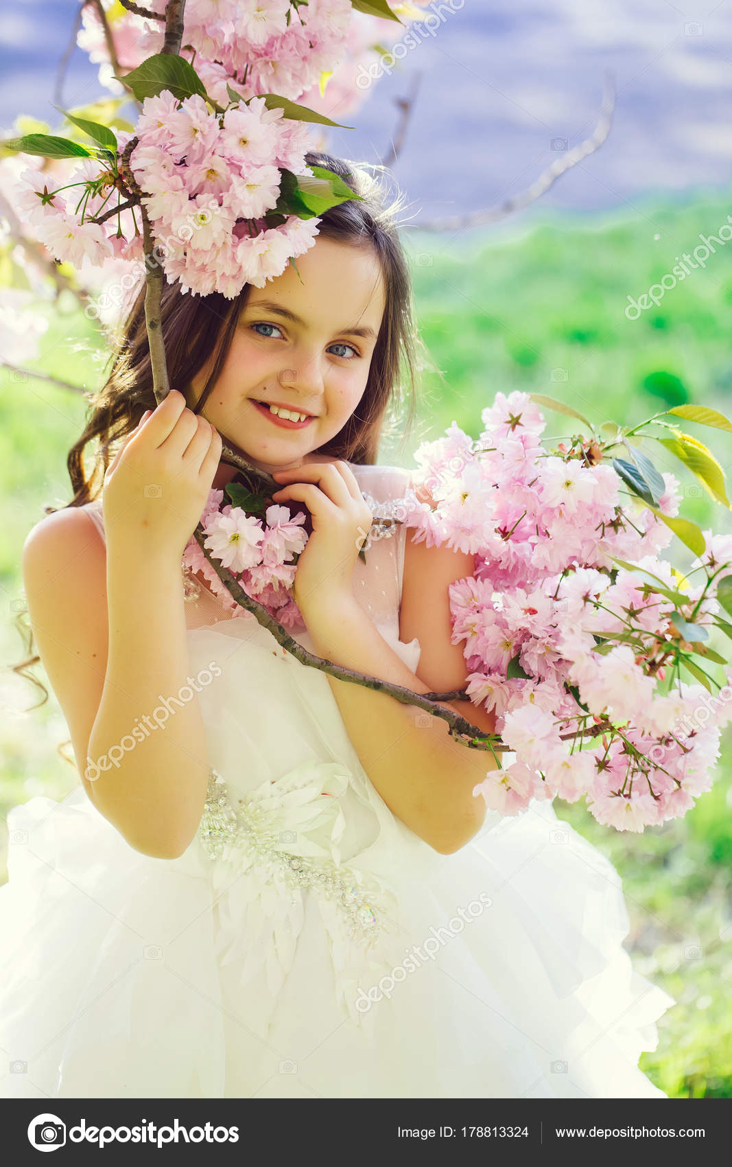 Little girl in spring bloom Stock Photo by ©Tverdohlib.com 178813324