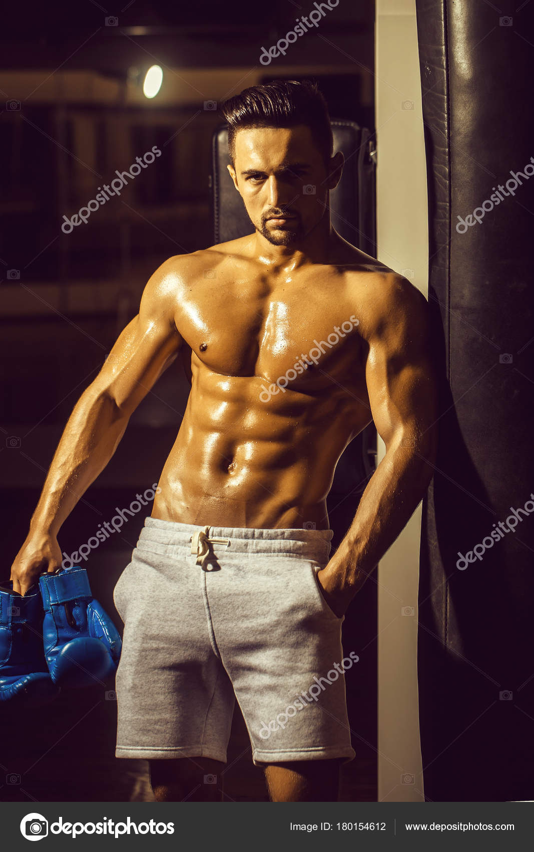 Muscular man with boxing gloves Stock Photo by ©Tverdohlib.com 180154612