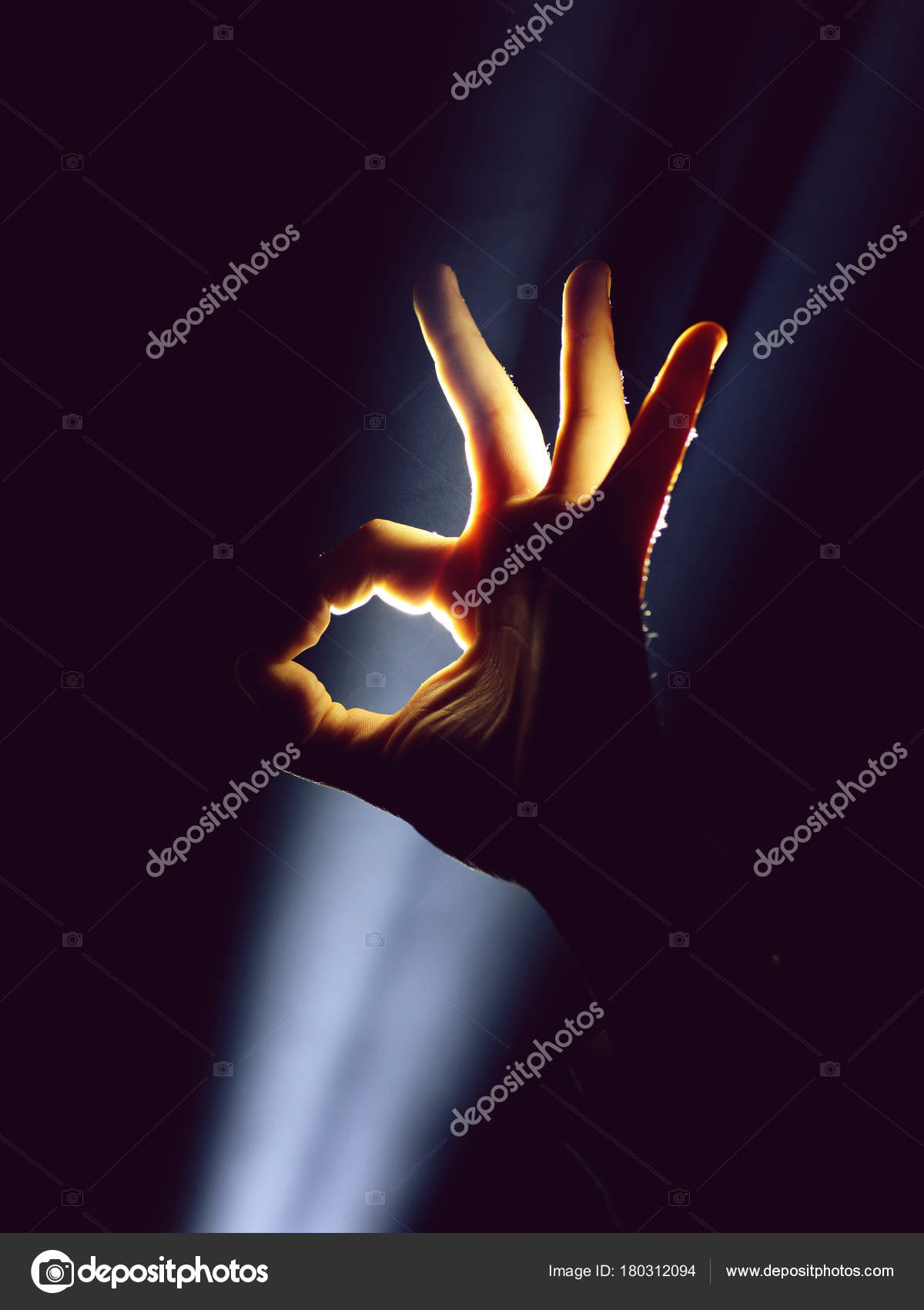 Hand gesture in spotlight Stock Photo by ©Tverdohlib.com 180312094