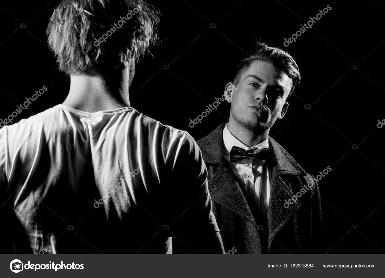 Two handsome men standing opposite Stock Photo by ©Tverdohlib.com 182313584