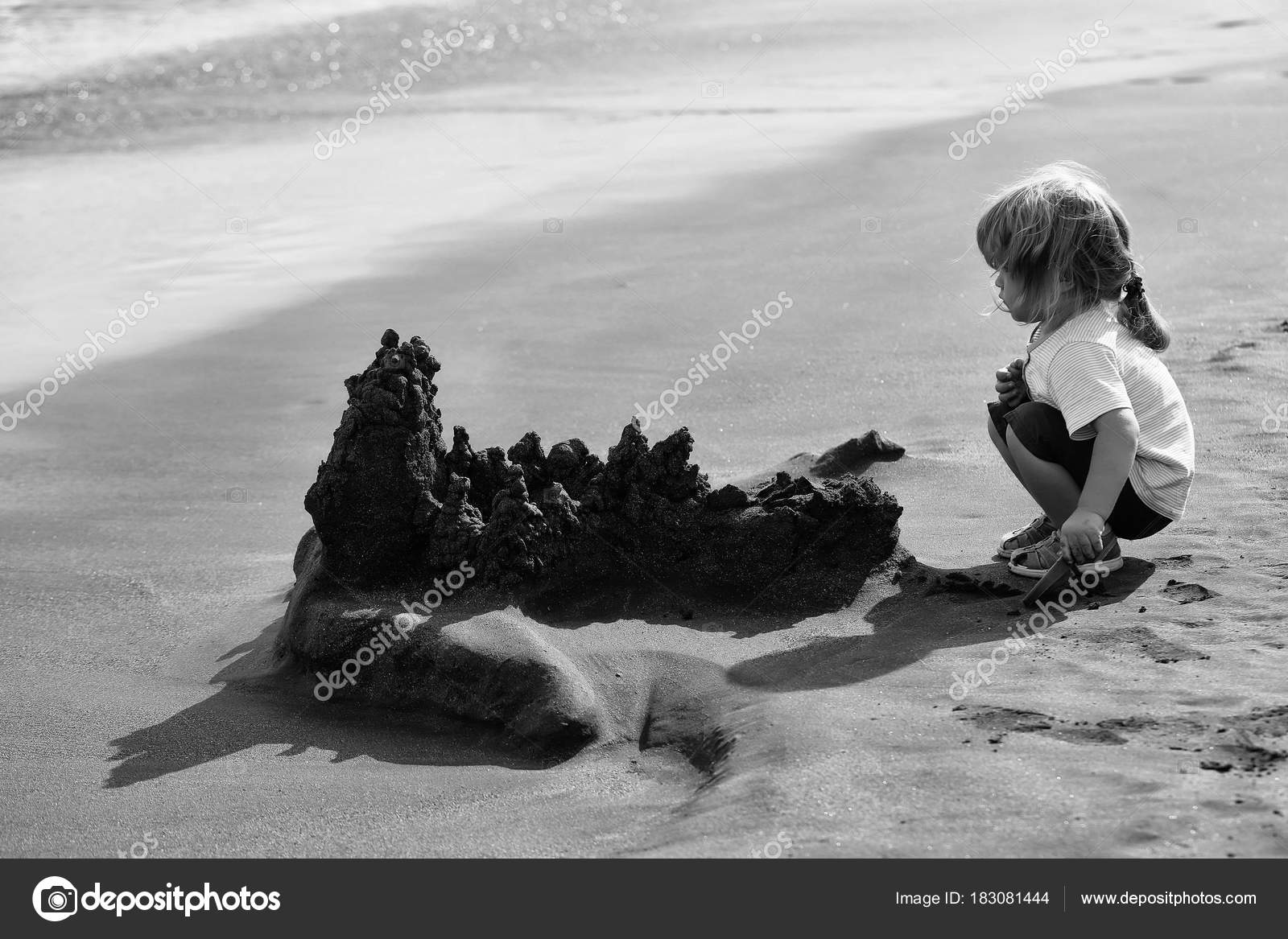 Cute baby boy builds sandcastle on sea beach Stock Photo by ©Tverdohlib ...