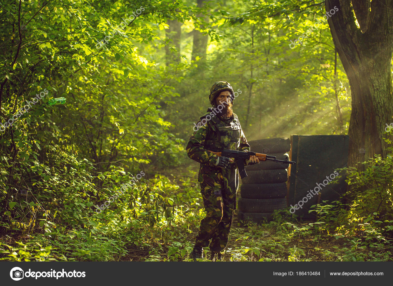 Soldier with rifle in forest Stock Photo by ©Tverdohlib.com 186410484