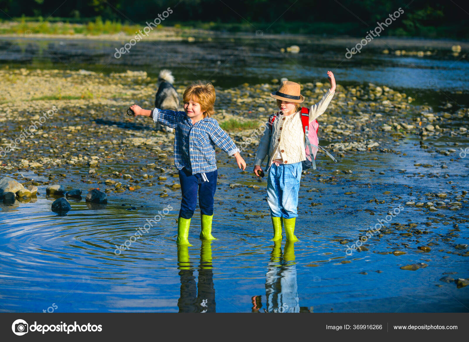 Kids throwing rocks. Two little sibling brothers ans sister playing in ...