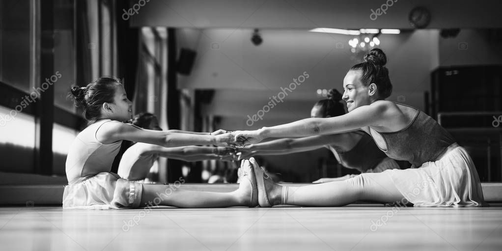 Ballet dancers doing stretching exercises ⬇ Stock Photo, Image by ...