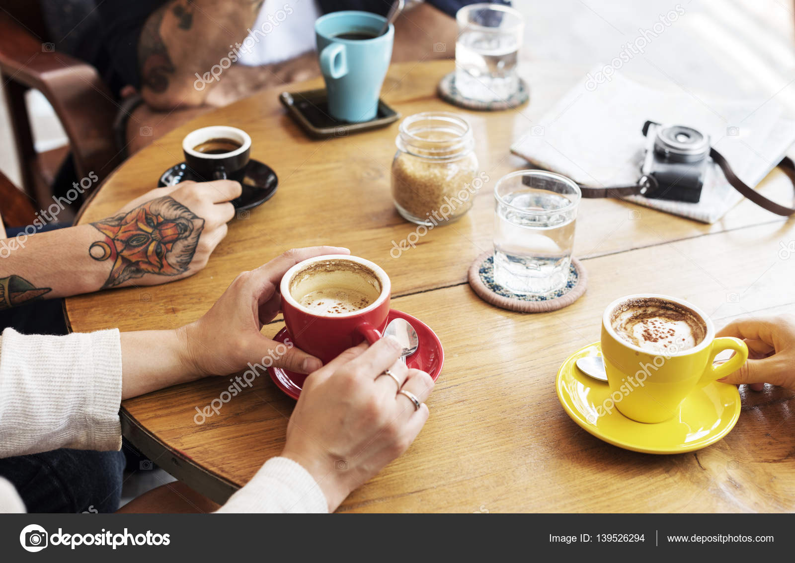 People Drinking Coffee In A Cafe