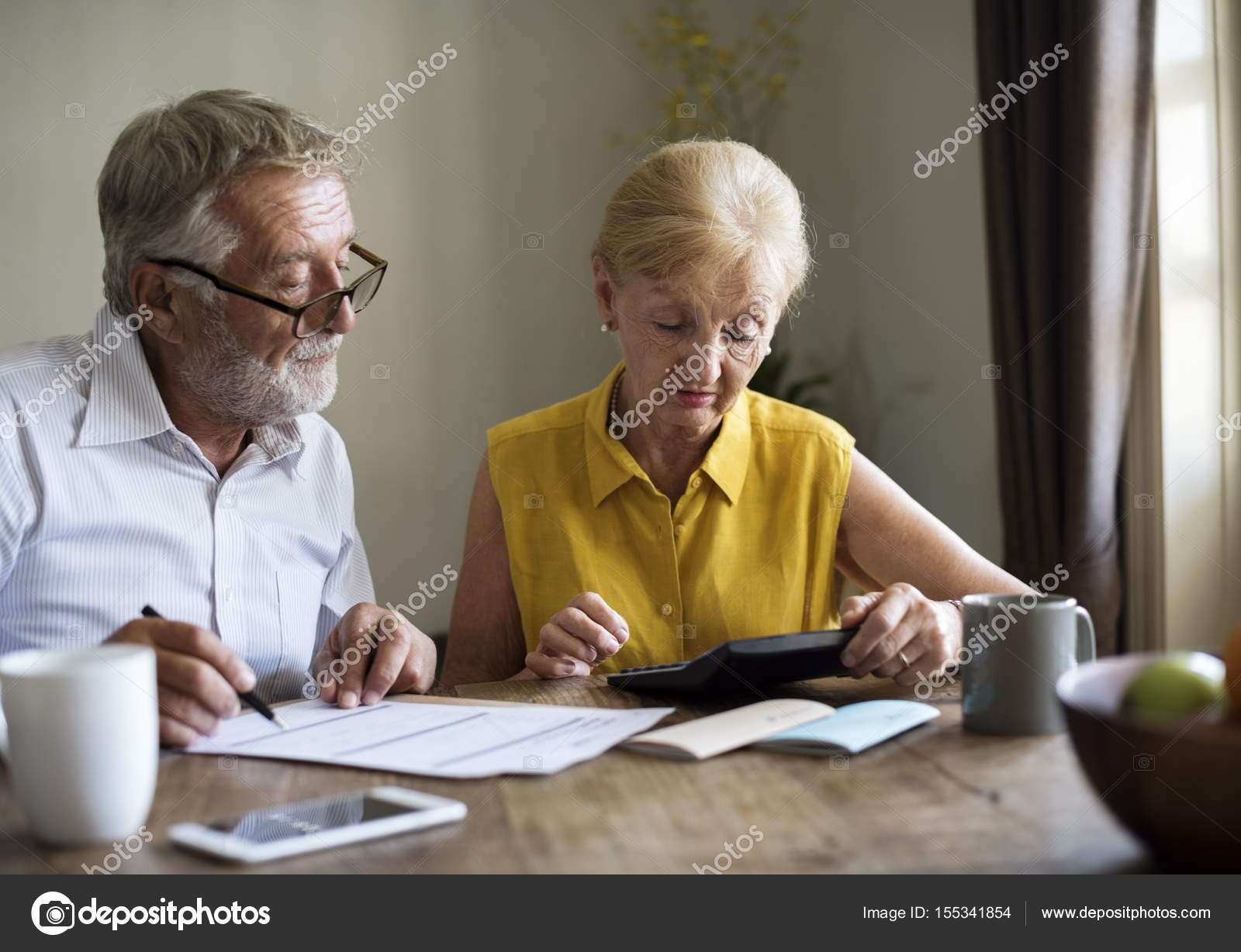 Senior couple reading documents — Stock Photo © Rawpixel #155341854