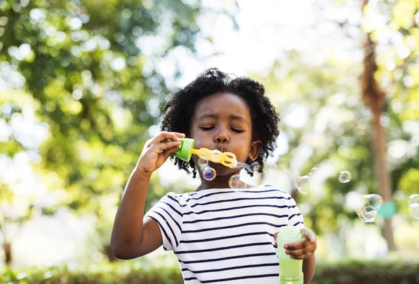 Children blowing bubbles Stock Photos, Royalty Free Children blowing ...