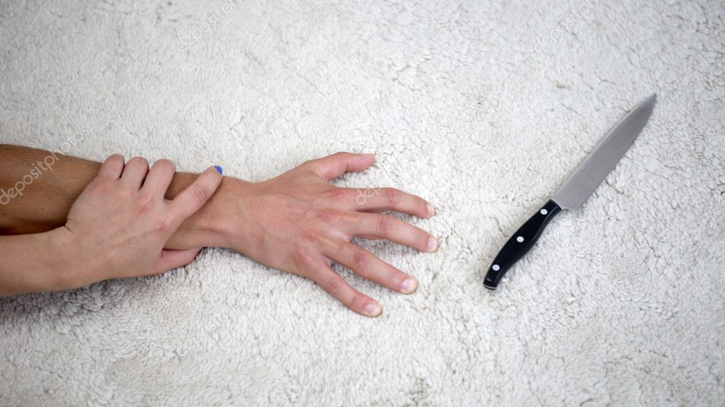 Closeup of man grabbing a knife and woman holding back Stock Photo by ...