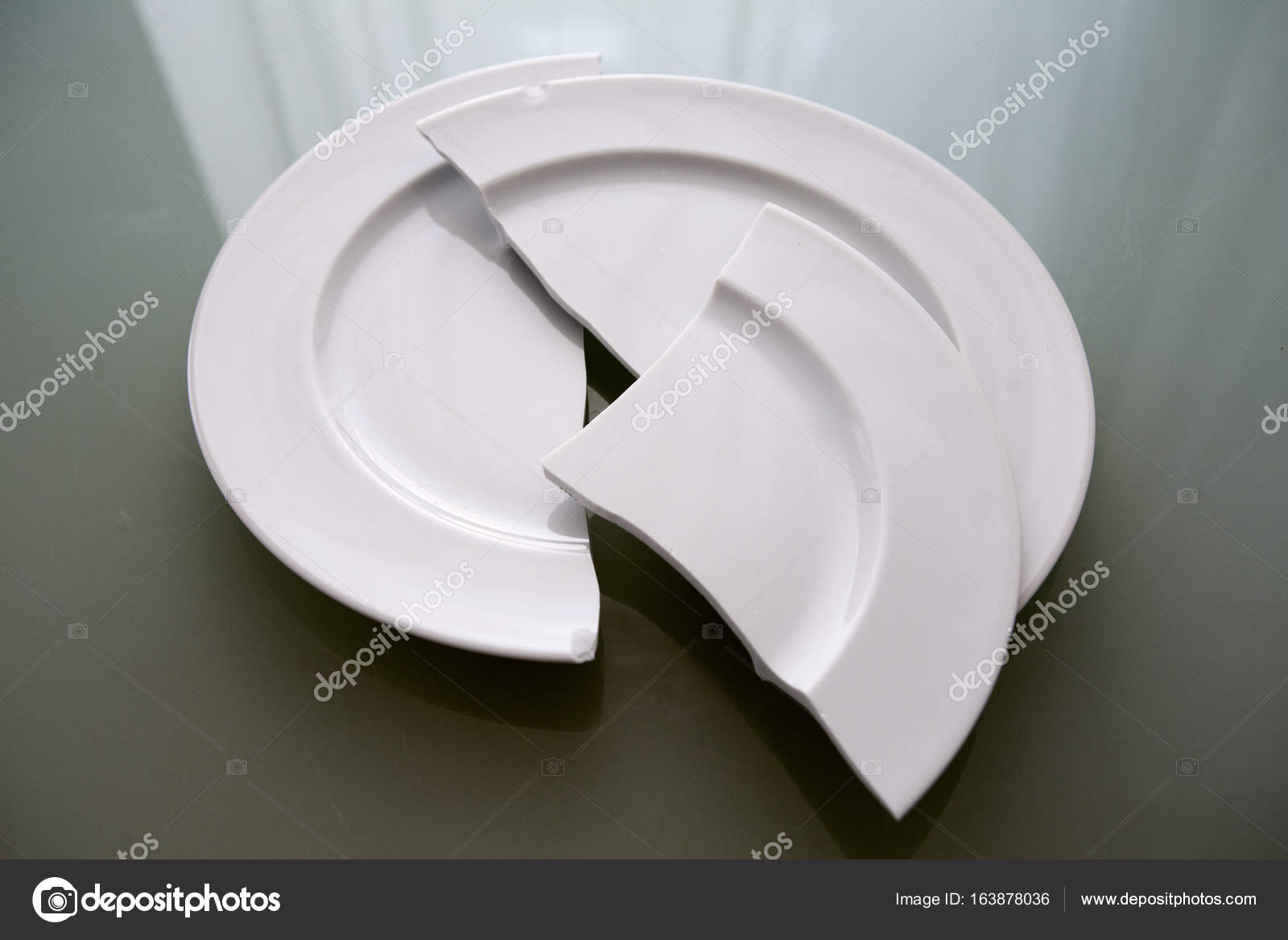 White broken plate on glass table — Stock Photo © wernerimages #163878036