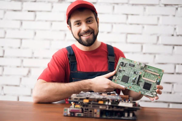 The master of electronic equipment repair keeps the details from the ...