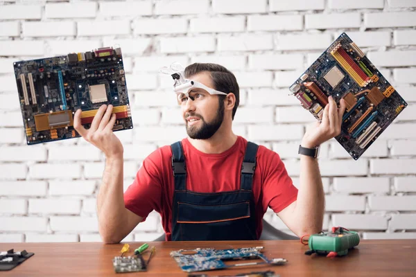 The master of electronic equipment repair keeps the details from the ...