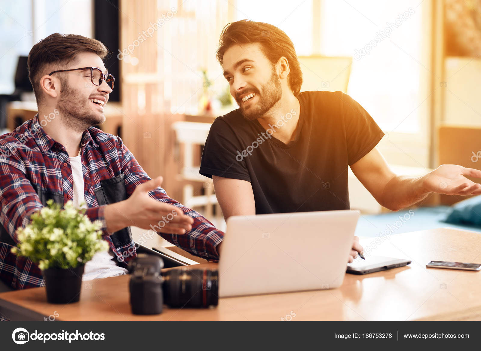 Two freelancer men discussing at laptop at desk. — Stock Photo © vadimphoto1@gmail.com #186753278
