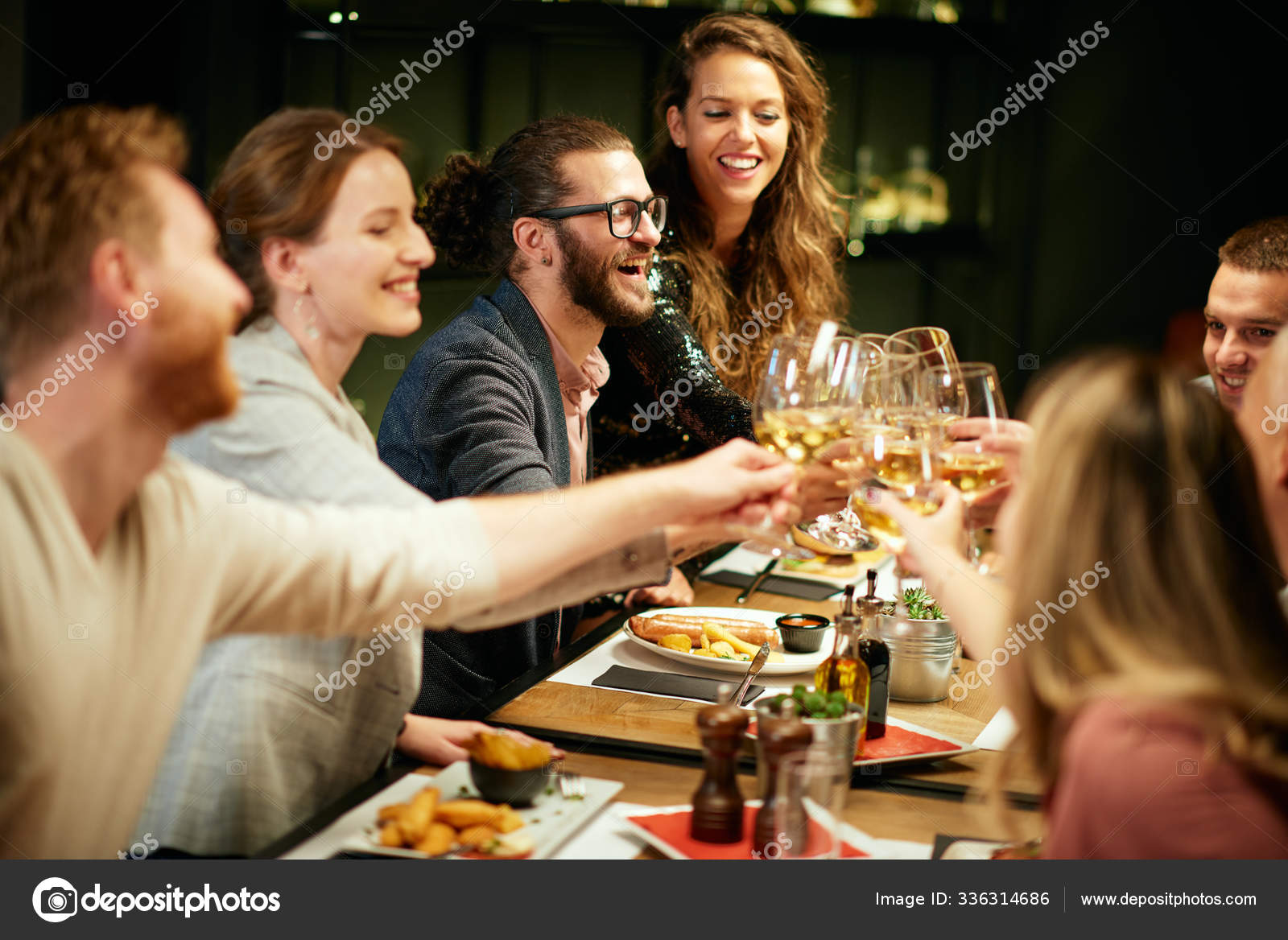 Best friends sitting in restaurant for dinner and making a toast with ...