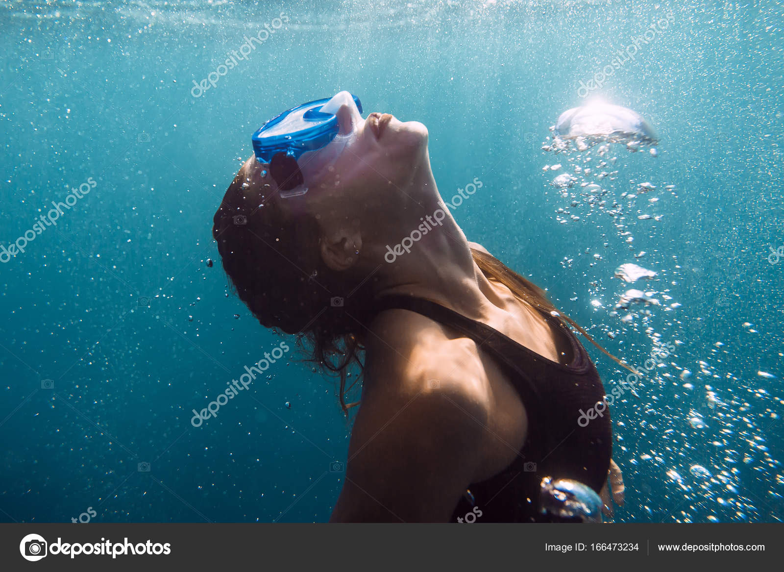 Woman floating in quiet ocean. Stock Photo by ©Keola 166473234