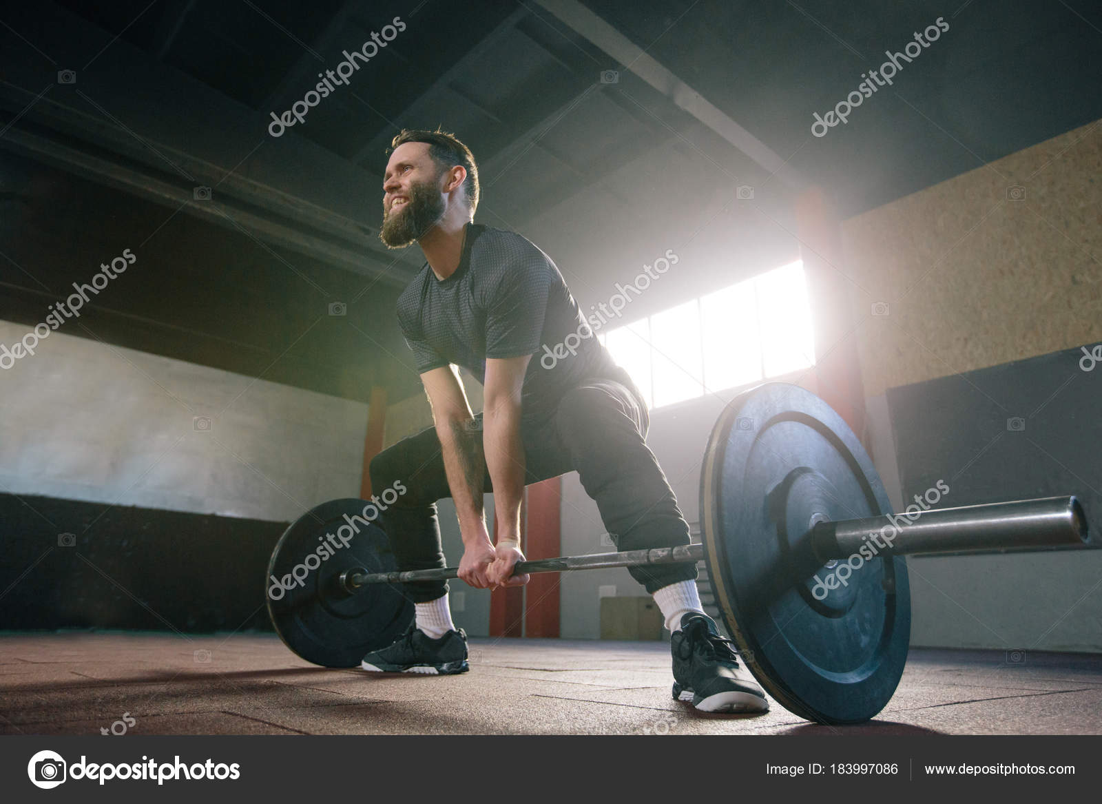 Athlete man with a beard exercising in a crossfit gym Stock Photo by ...
