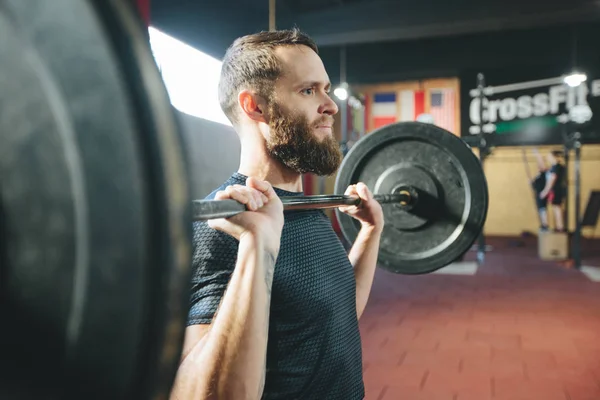 Athlete man with a beard exercising in a crossfit gym Stock Photo by ...